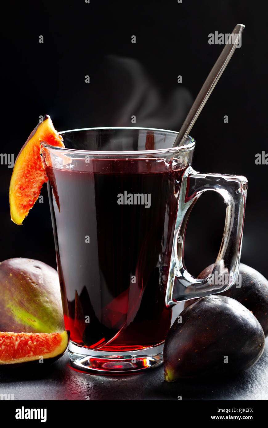 Hot fig tea with fresh figs in front of black background Stock Photo ...