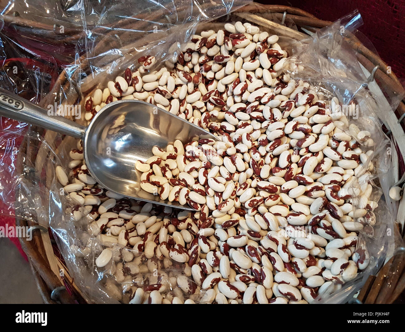 Basket filled with beans, scoop Stock Photo - Alamy
