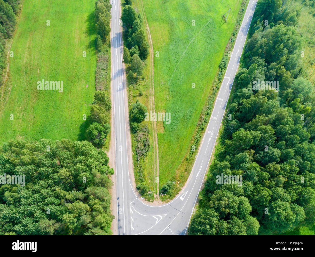 Aerial view of highway. Aerial view of a country road. Car passing by ...