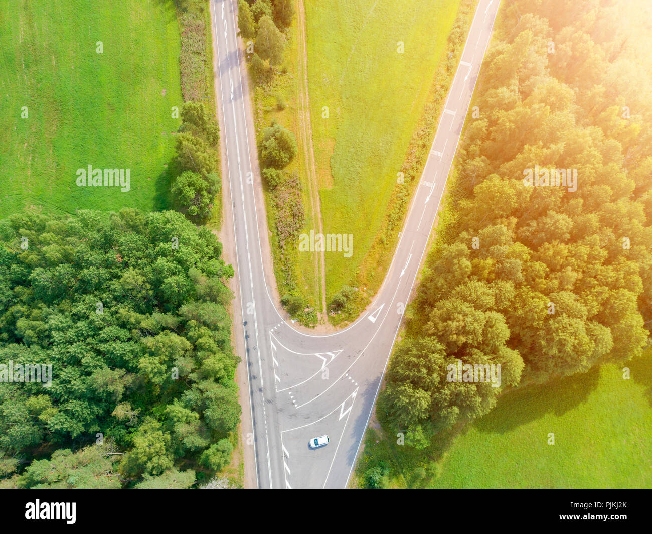Aerial view of highway with car. Aerial view of a country road with ...