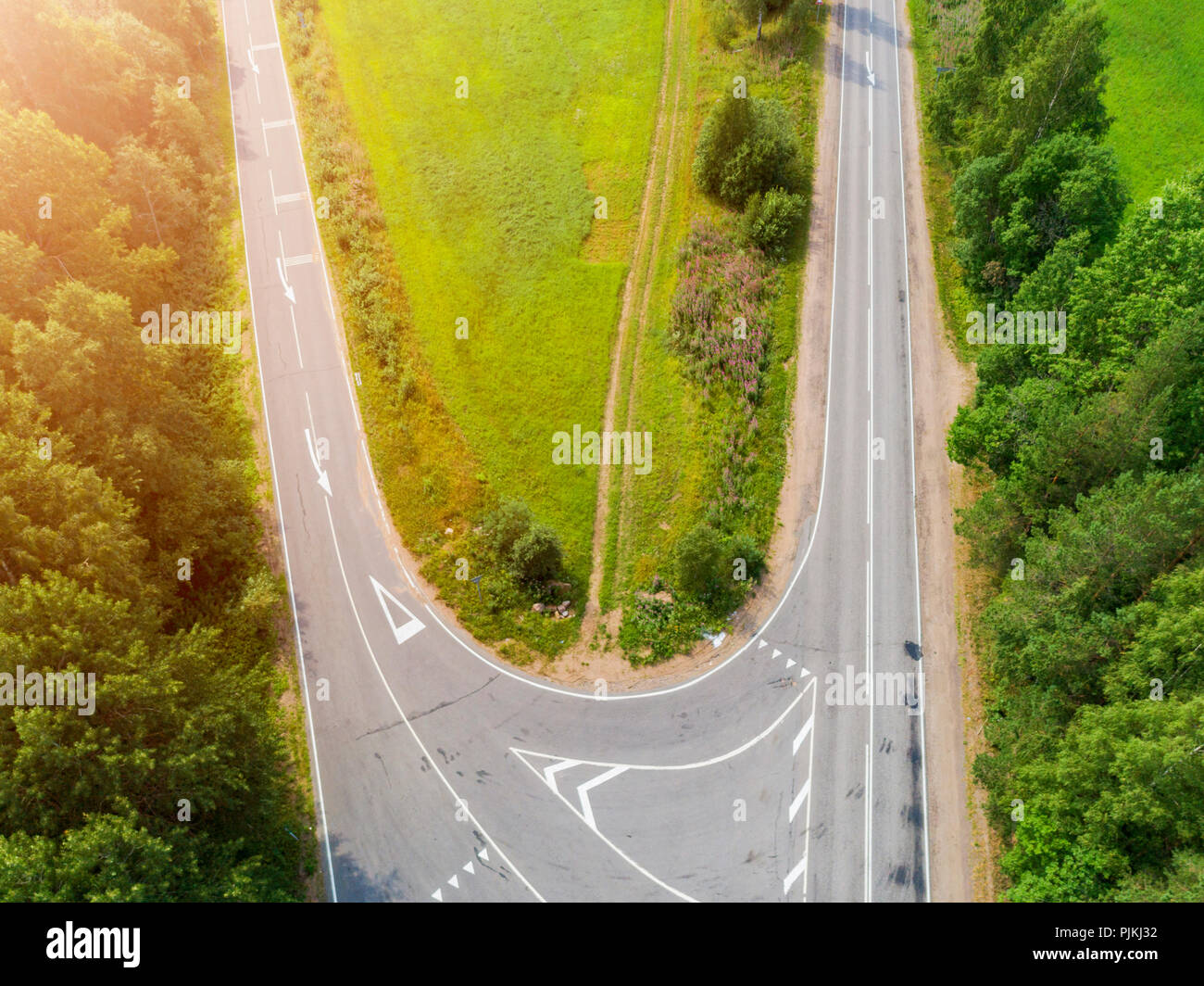Aerial view of highway. Aerial view of a country road. Car passing by ...