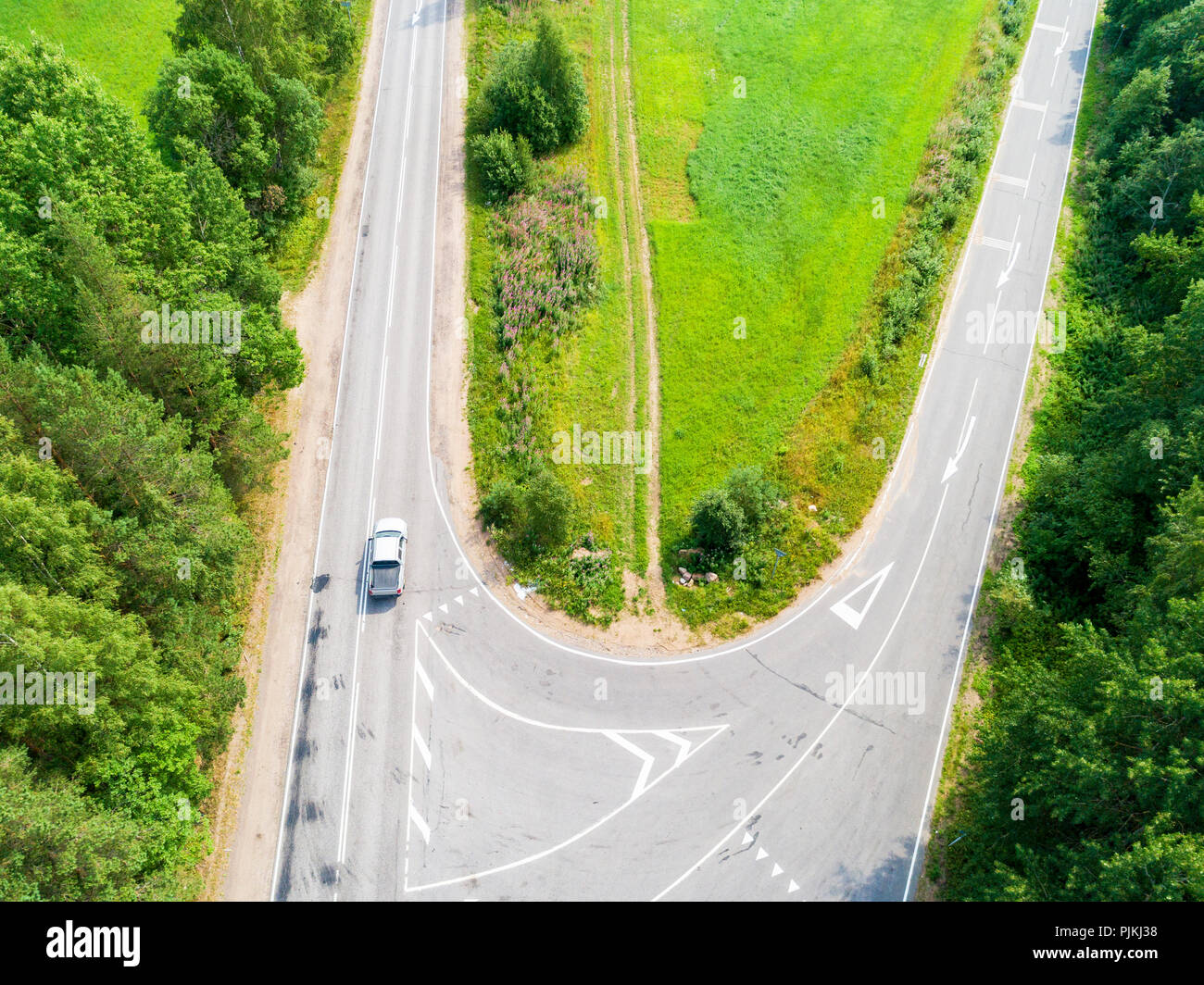 Aerial view of highway with car. Aerial view of a country road with ...