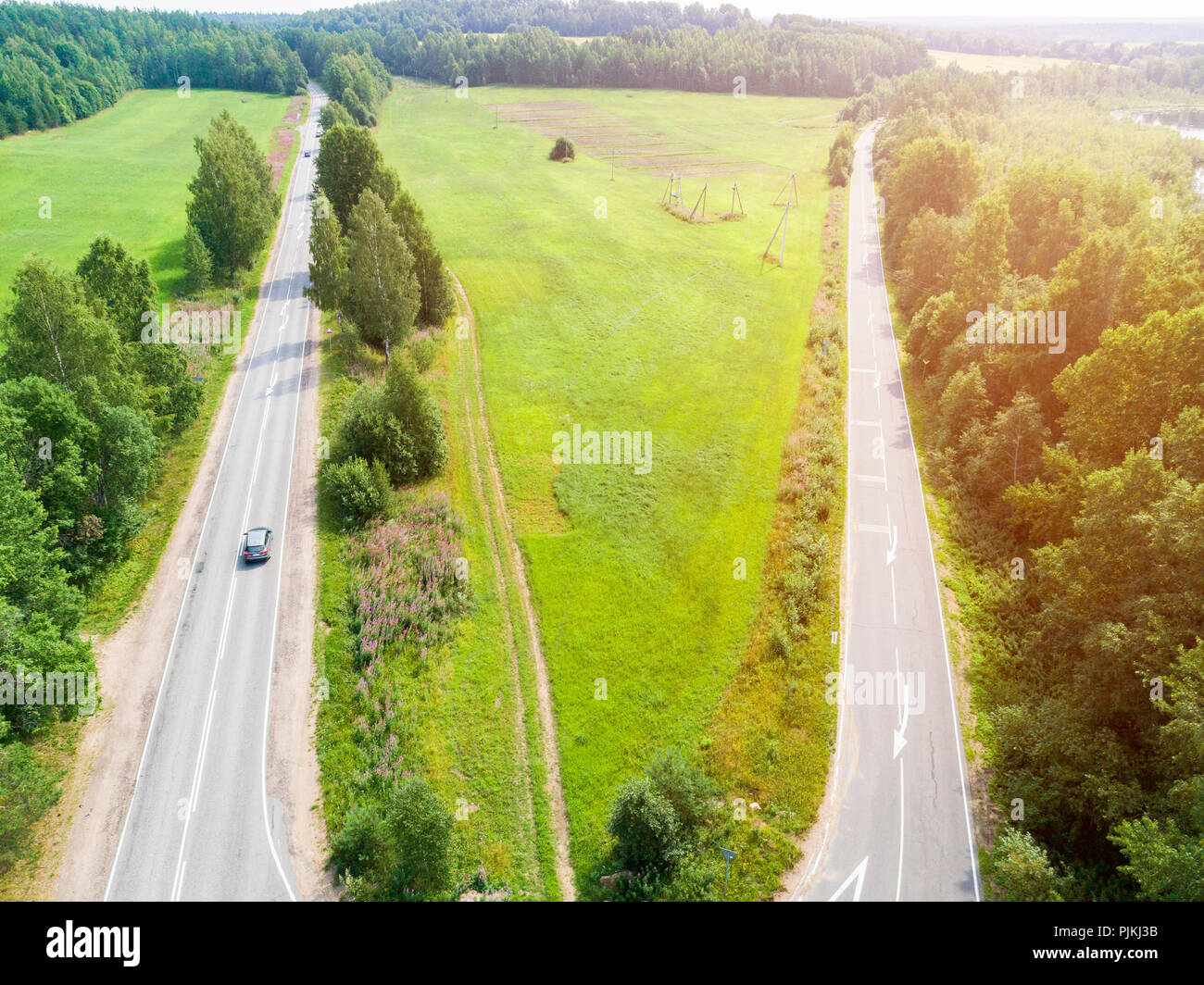 Aerial view of highway with car. Aerial view of a country road with ...