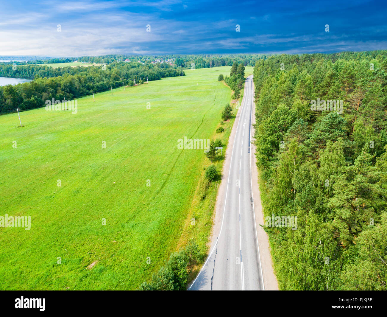 Aerial view of highway. Aerial view of a country road near the lake ...