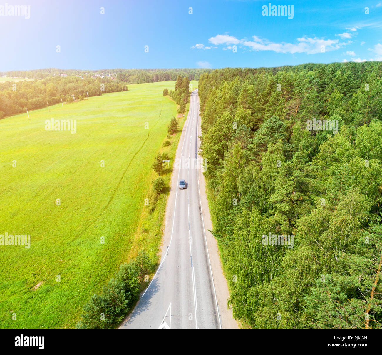 Aerial view of highway with car. Aerial view of a country road with ...
