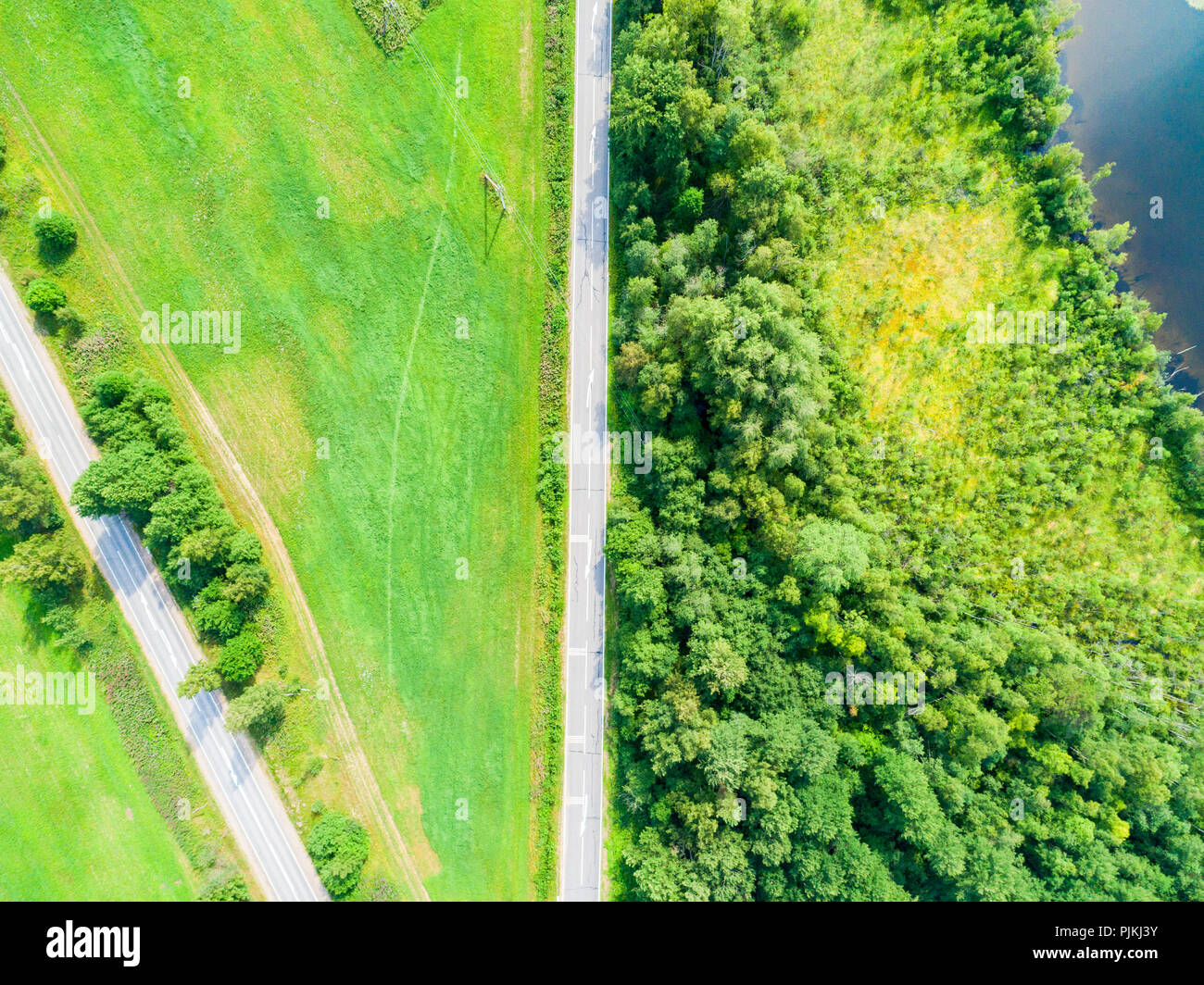 Aerial view of highway. Aerial view of a country road near the lake ...