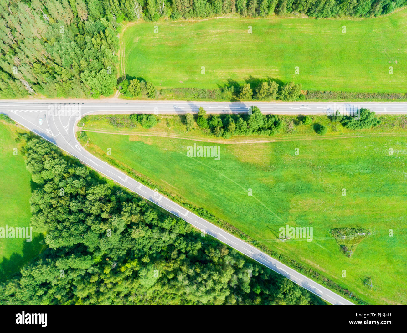Aerial view of highway. Aerial view of a country road near the lake ...