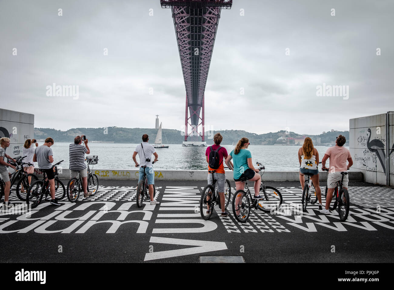 Tourist and locals enjoying the view under the 25 April bridge (Ponte ...