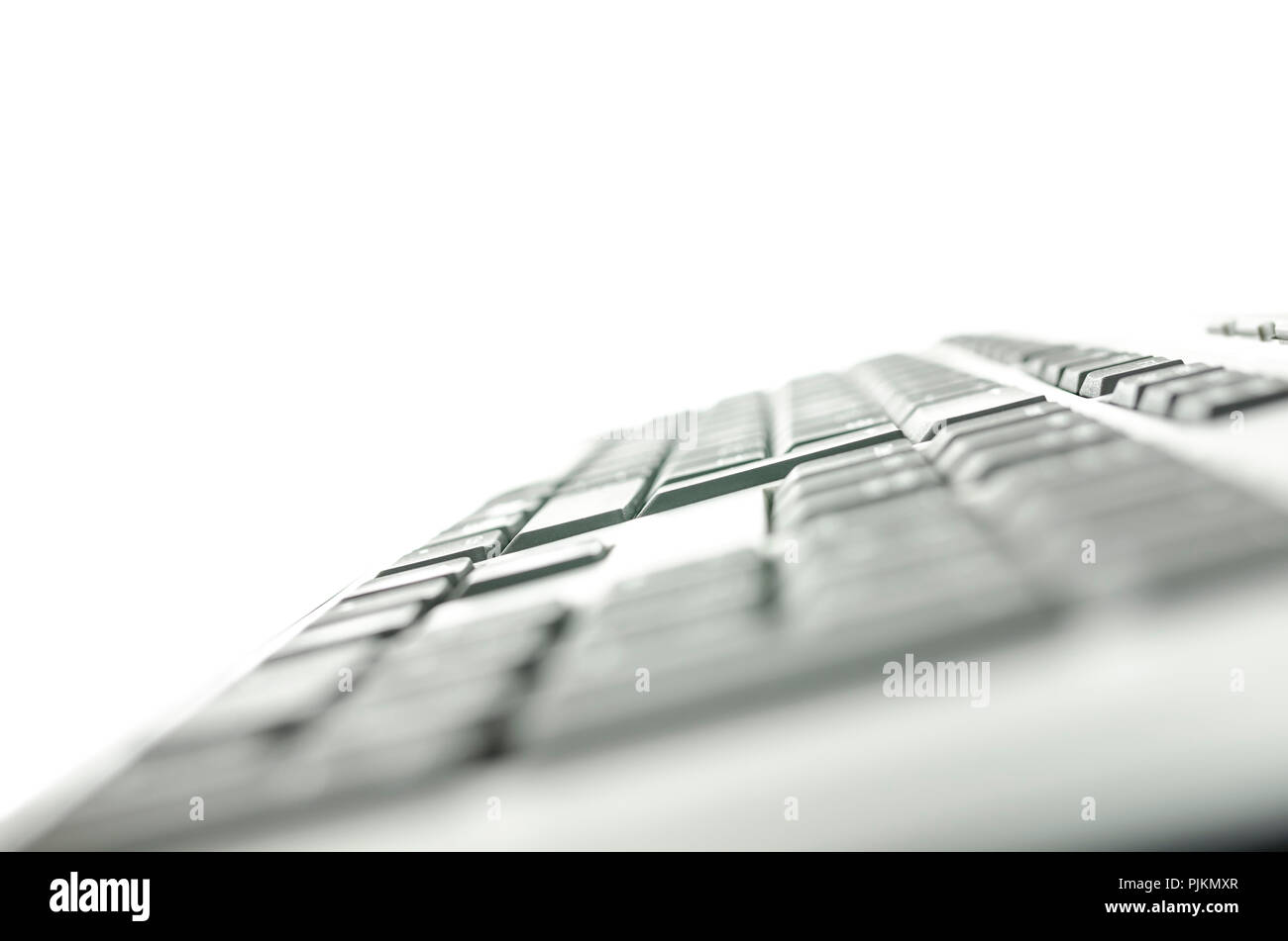 Side view of computer keyboard isolated over white background. Shallow ...