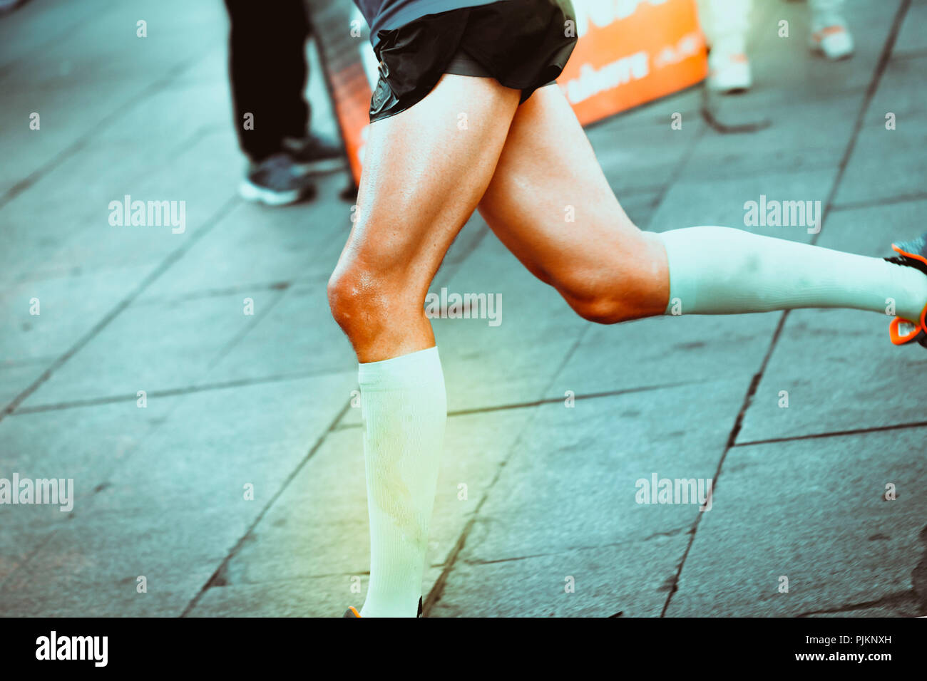 Long Distance in the Big City - marathon runners, legs, close-up ...