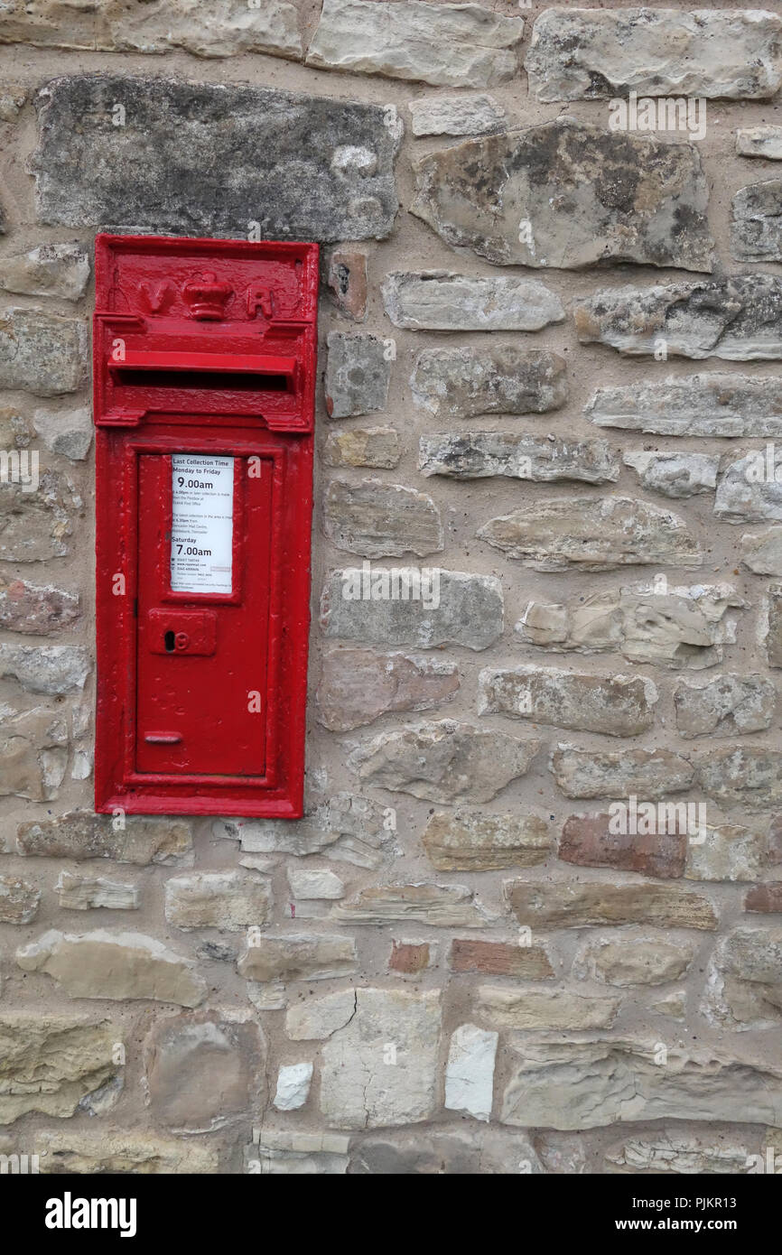 English village post box built into large stone wall Stock Photo - Alamy