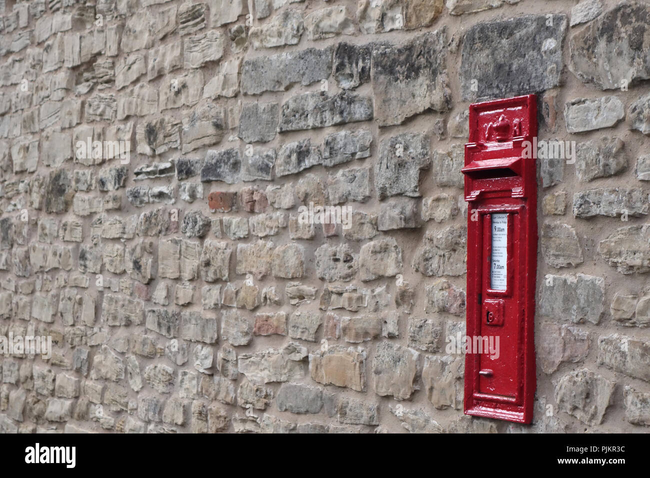 English village post box built into large stone wall Stock Photo - Alamy
