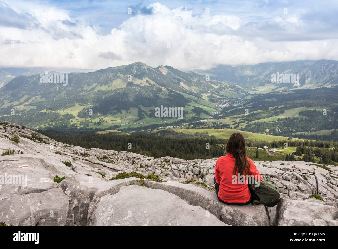 Woman hiking in the karst field Schrattenfluh, landscape in the ...