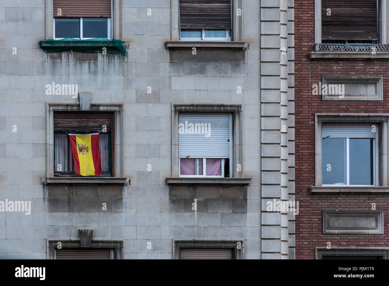 Spanish flag in front of a window in Barcelona Stock Photo - Alamy