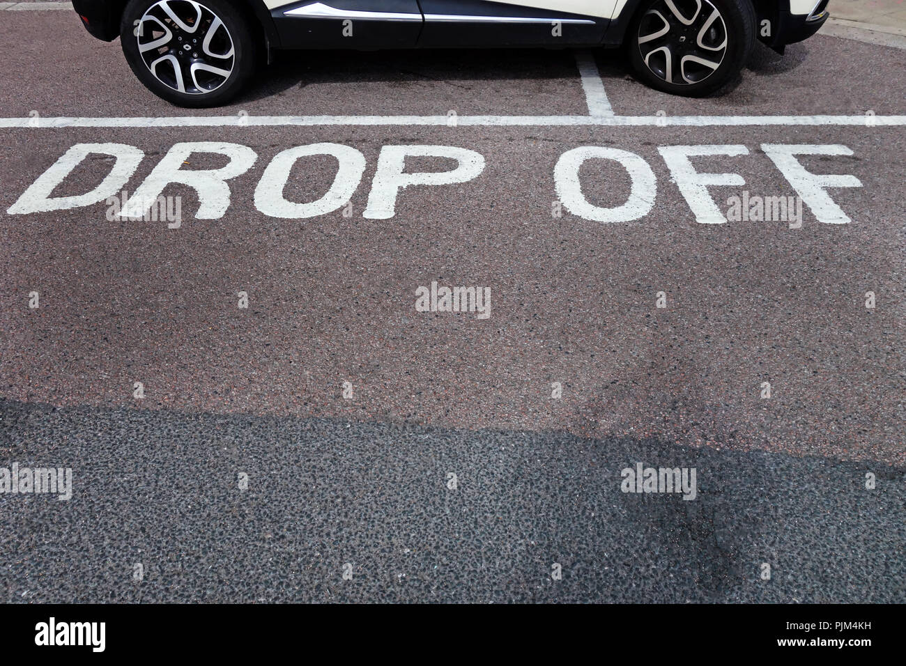 The words 'Drop off' written on road surface in a car park Stock Photo ...