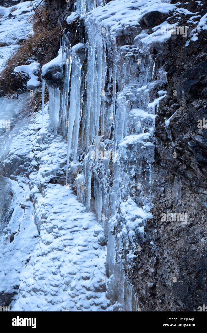 Icicles on a steep rock face Stock Photo - Alamy