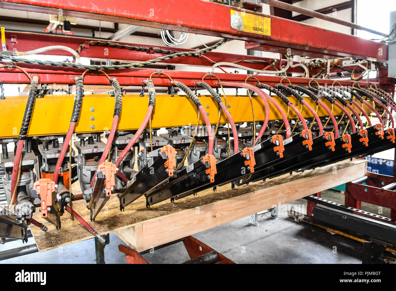 Construction equipment in warehouse use to build frames for new homes ...