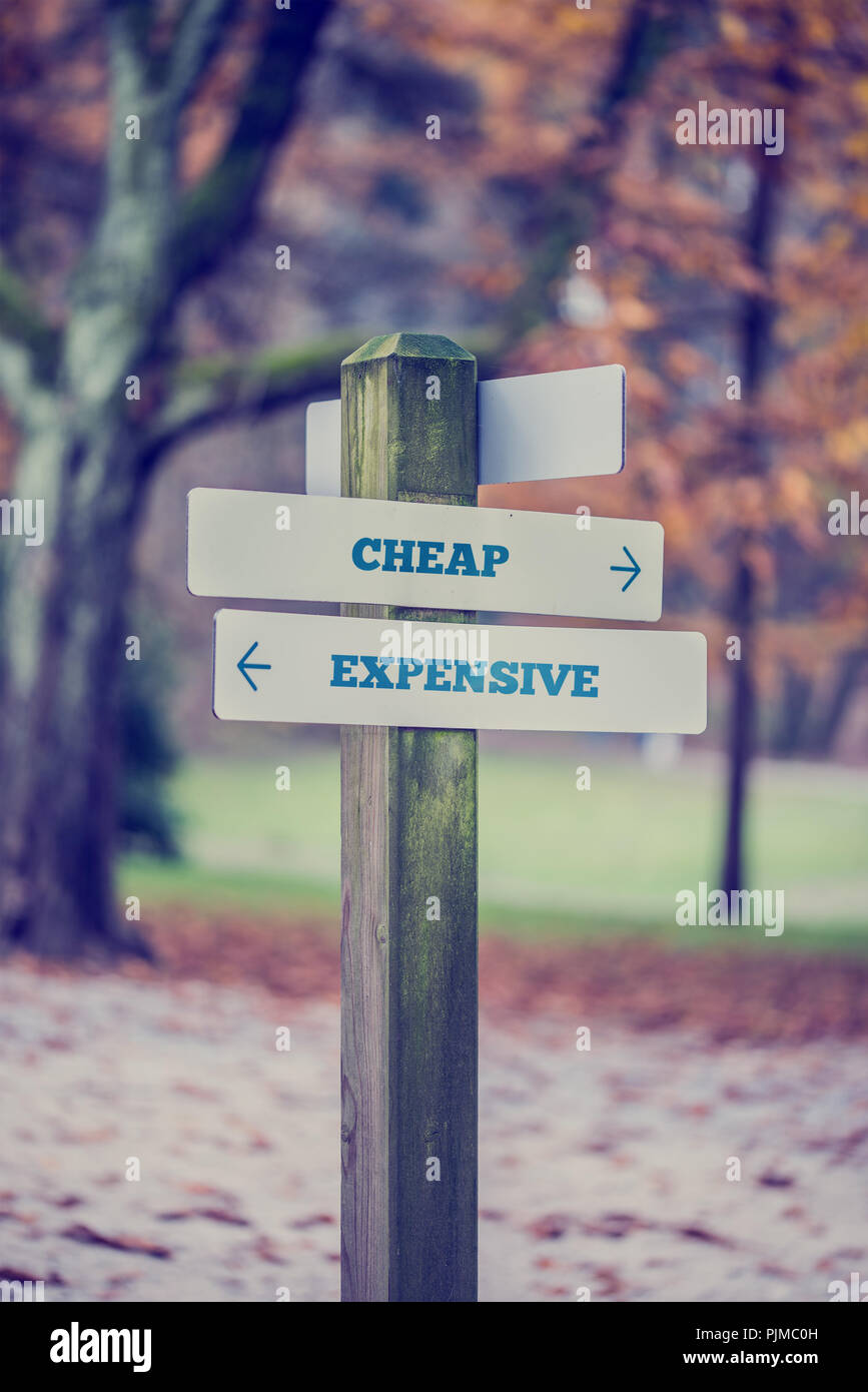 Rural Signboard With Two Signs Saying Cheap Expensive Pointing In Opposite Directions rural-signboard-with-two-signs-saying-cheap-expensive-pointing-in-opposite-directions