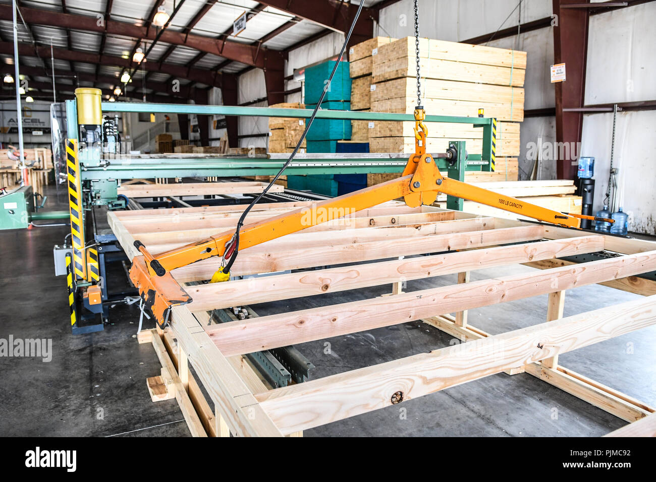 Construction equipment in warehouse use to build frames for new homes ...