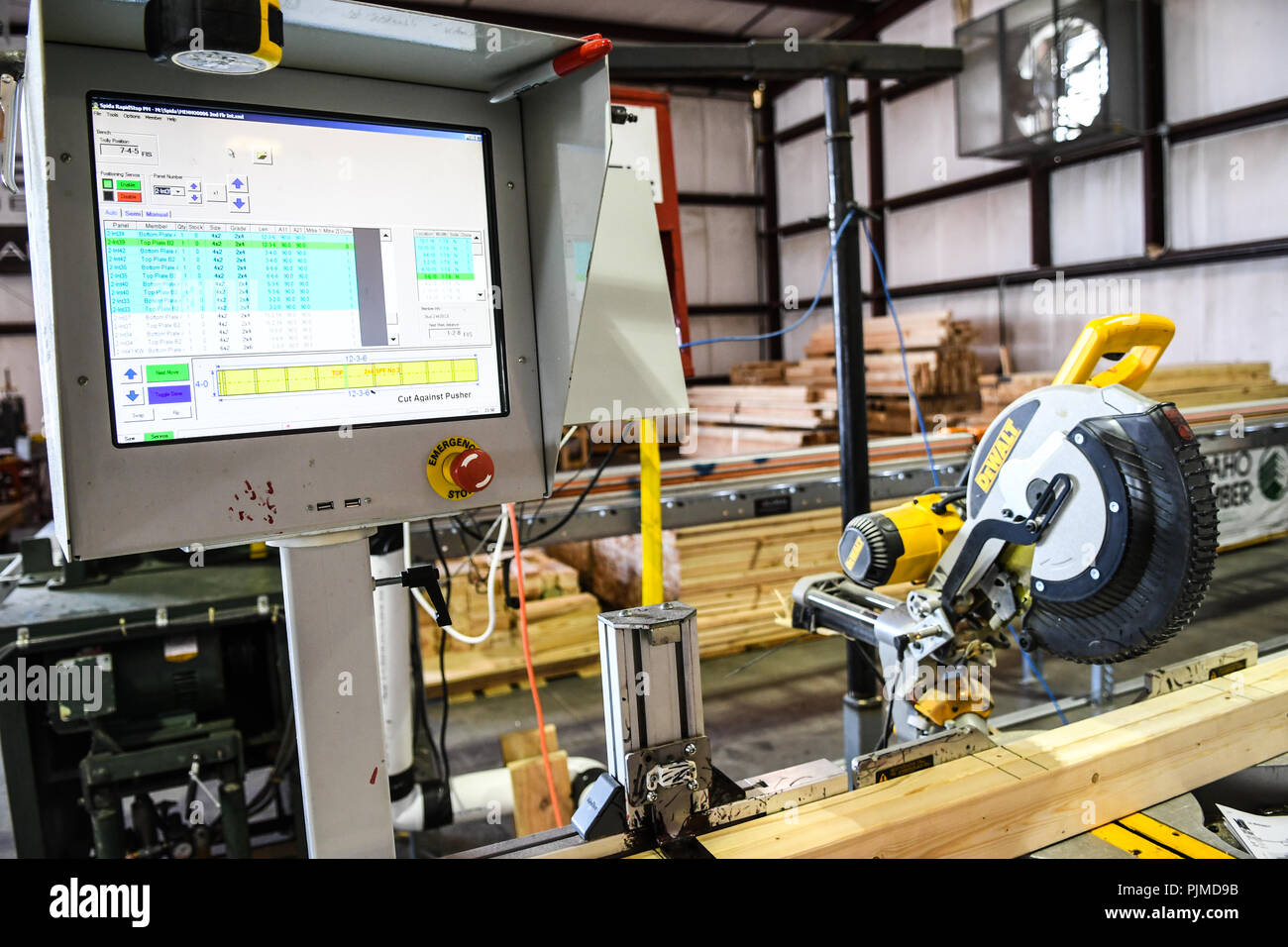 Construction equipment in warehouse use to build frames for new homes ...