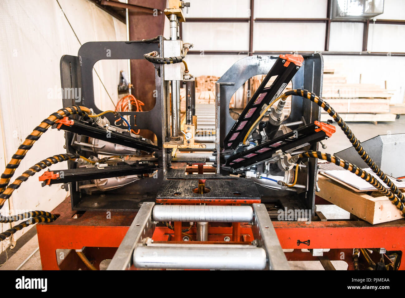 Construction equipment in warehouse use to build frames for new homes ...