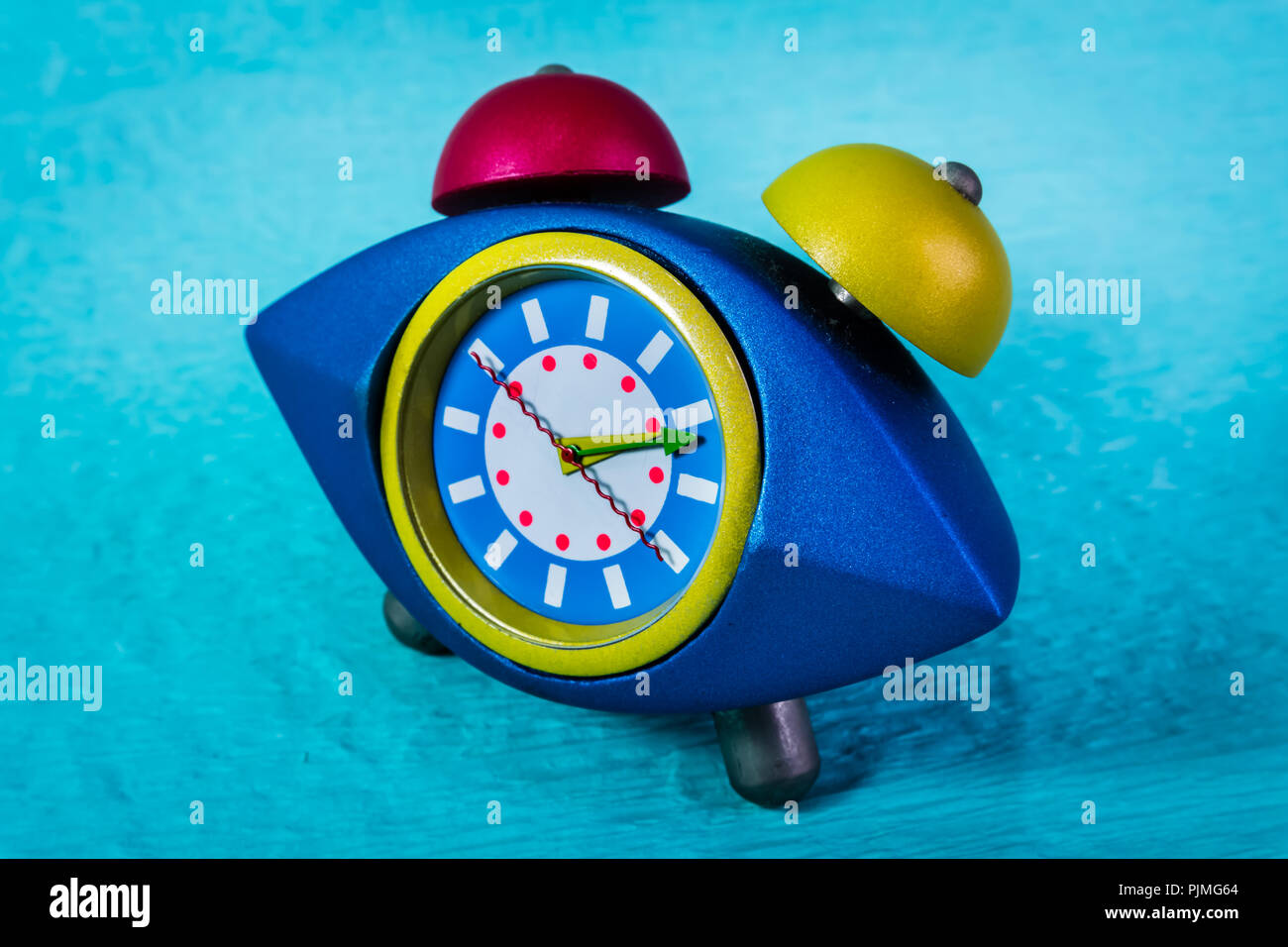 Colorful alarm clock isolated on a blue colored background Stock Photo ...