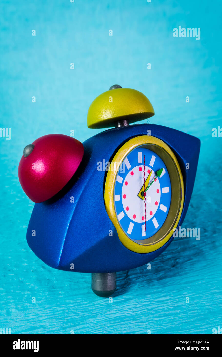 Colorful alarm clock isolated on a blue colored background Stock Photo ...