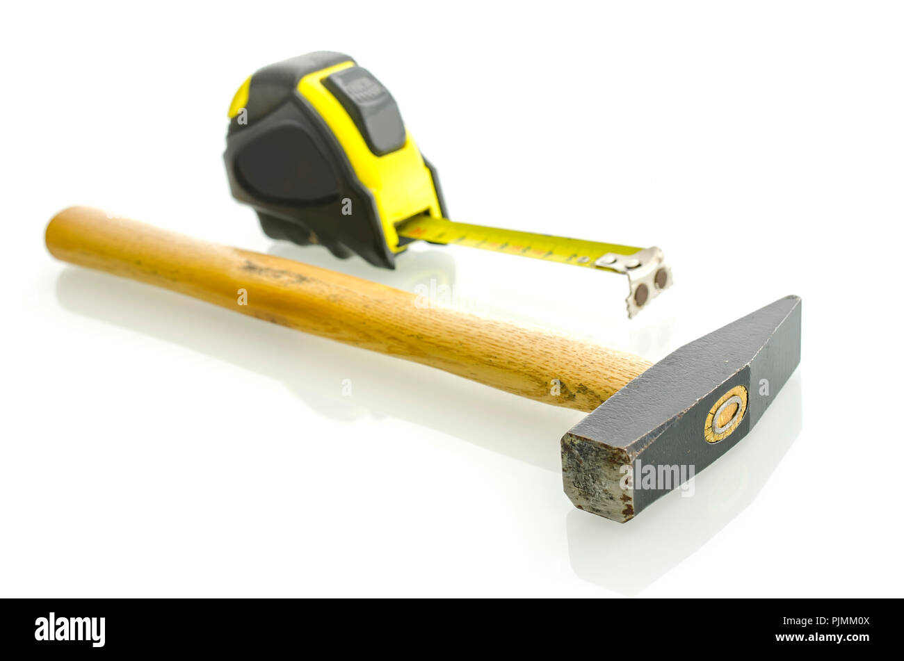 Hammer and measuring tape isolated over white background Stock Photo ...