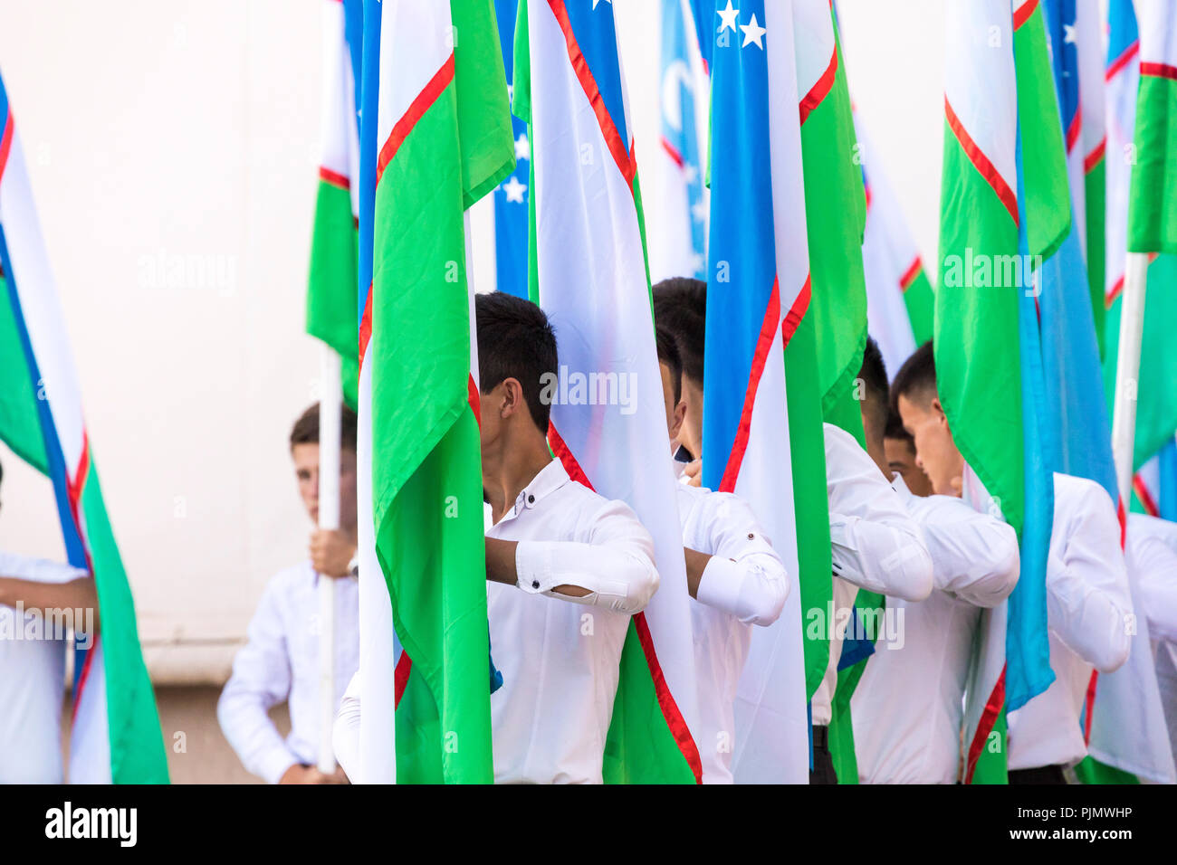 KHIVA, UZBEKISTAN - AUGUST 26, 2018: Young peoples with national flag ...