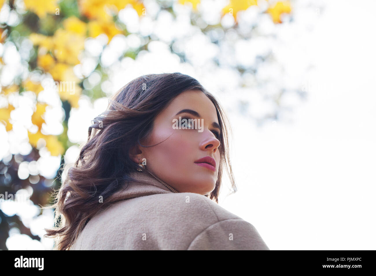 Young woman looking back in park outdoors Stock Photo - Alamy