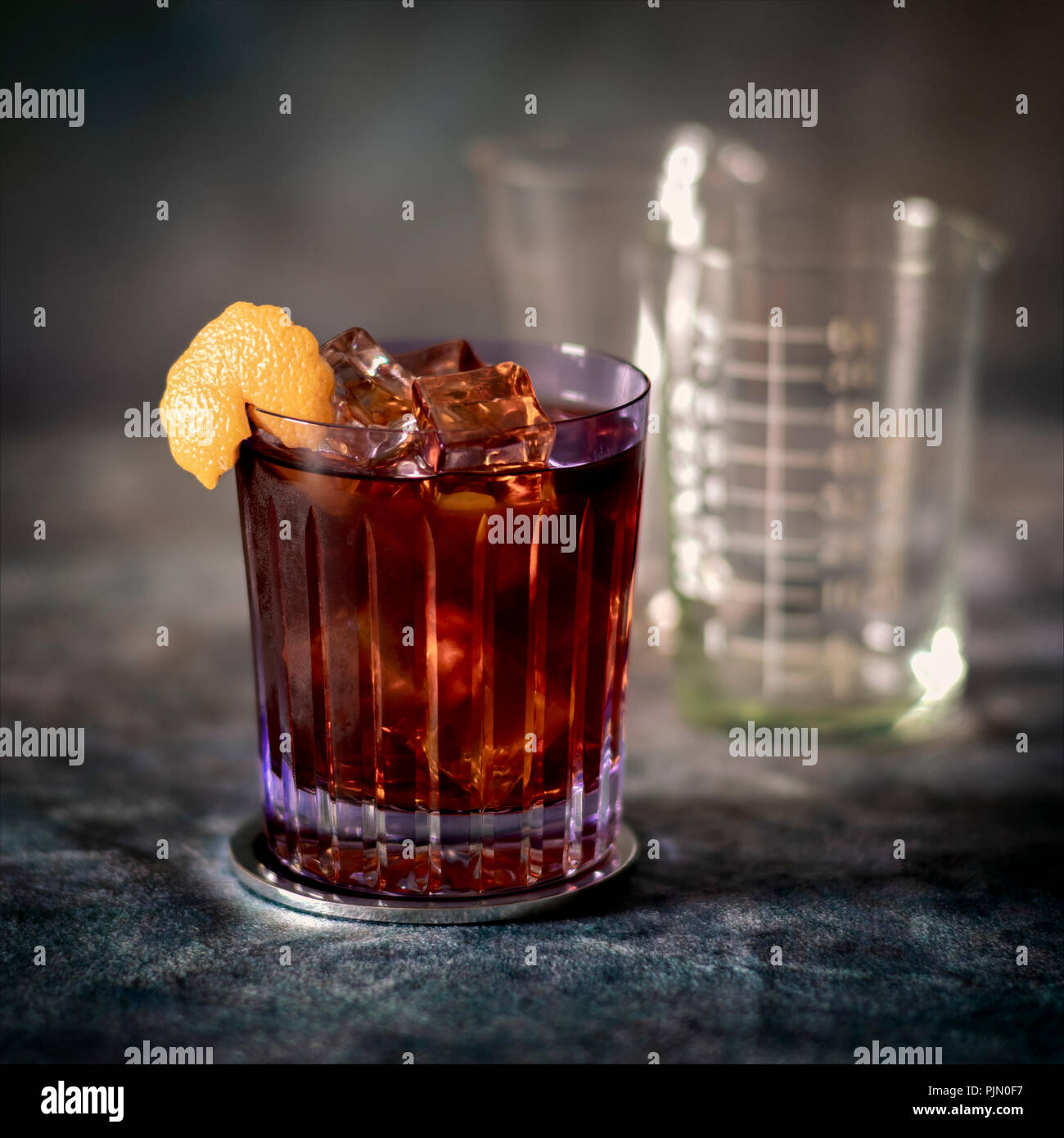 Rum based alcoholic drink in tumbler with mixing glasses hi-res stock ...
