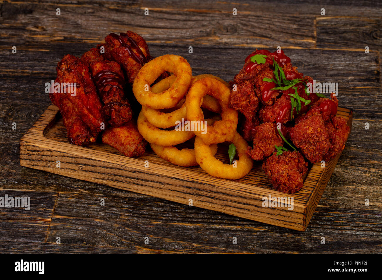 Chicken wings, leg and onion fry plate Stock Photo - Alamy