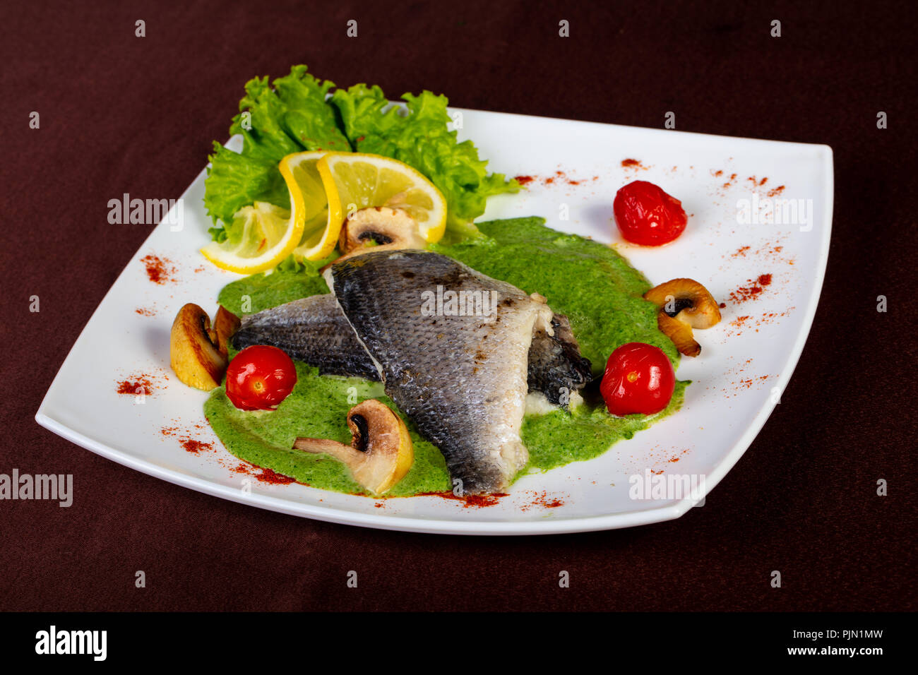 Steamed Dorada fish fillet with sauce Stock Photo - Alamy