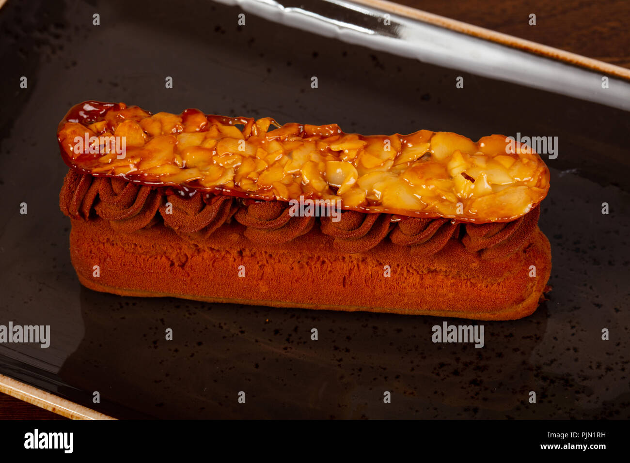 Tasty sweet Eclair with cream Stock Photo - Alamy