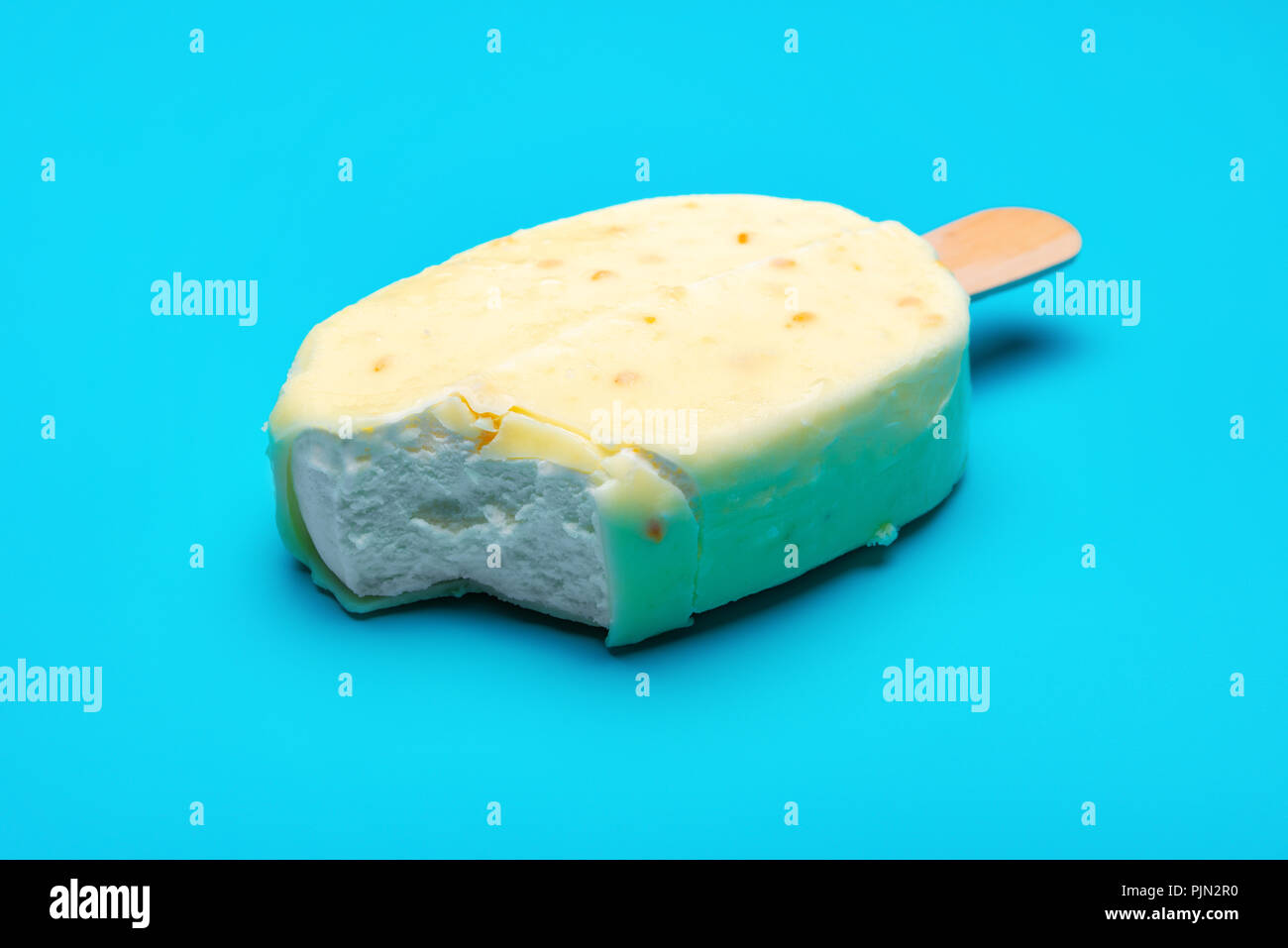 white popsicle with a bite on blue background Stock Photo - Alamy