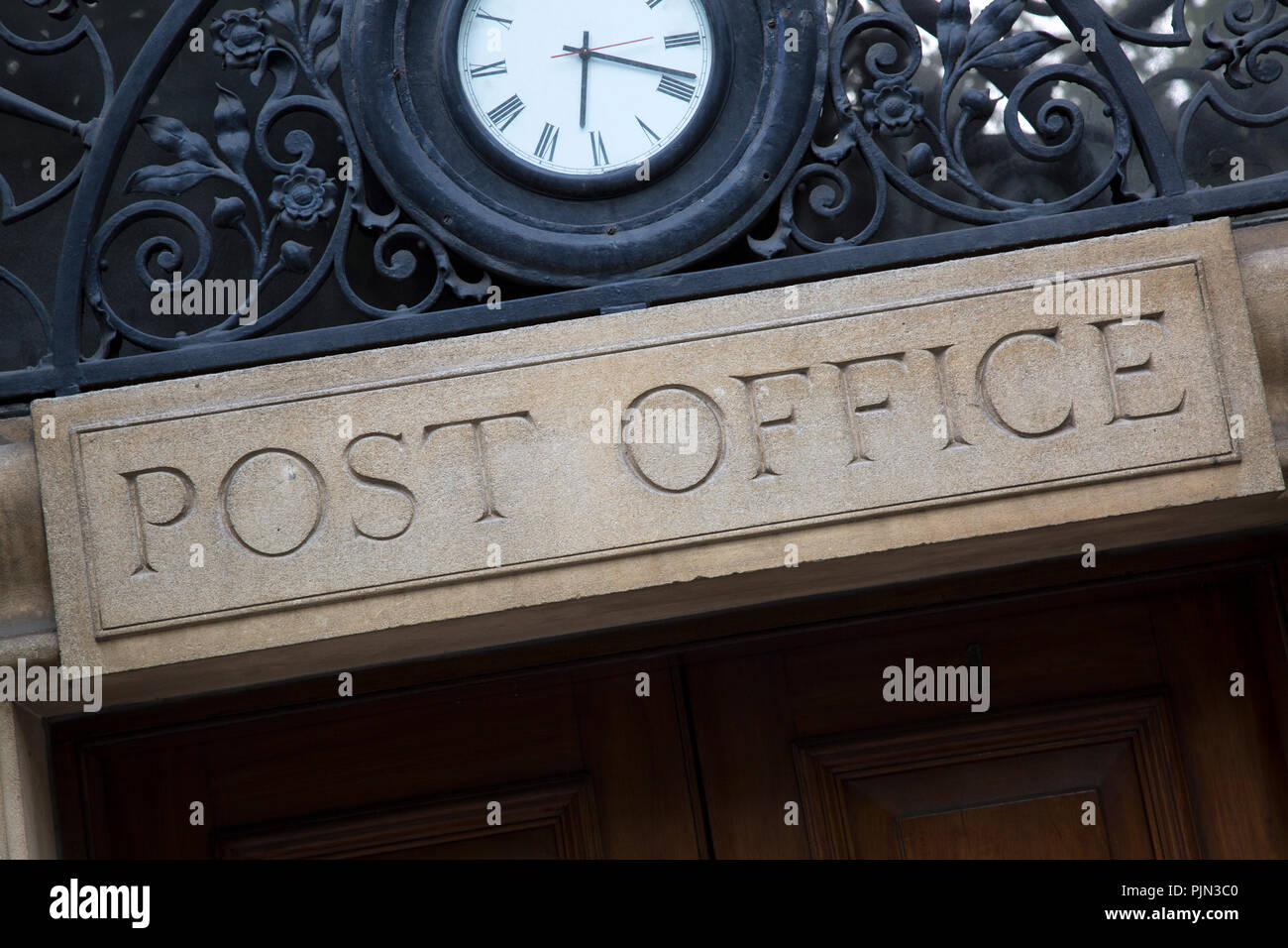 Post Office on Diagonal Slant with Clock Sign, England Stock Photo - Alamy