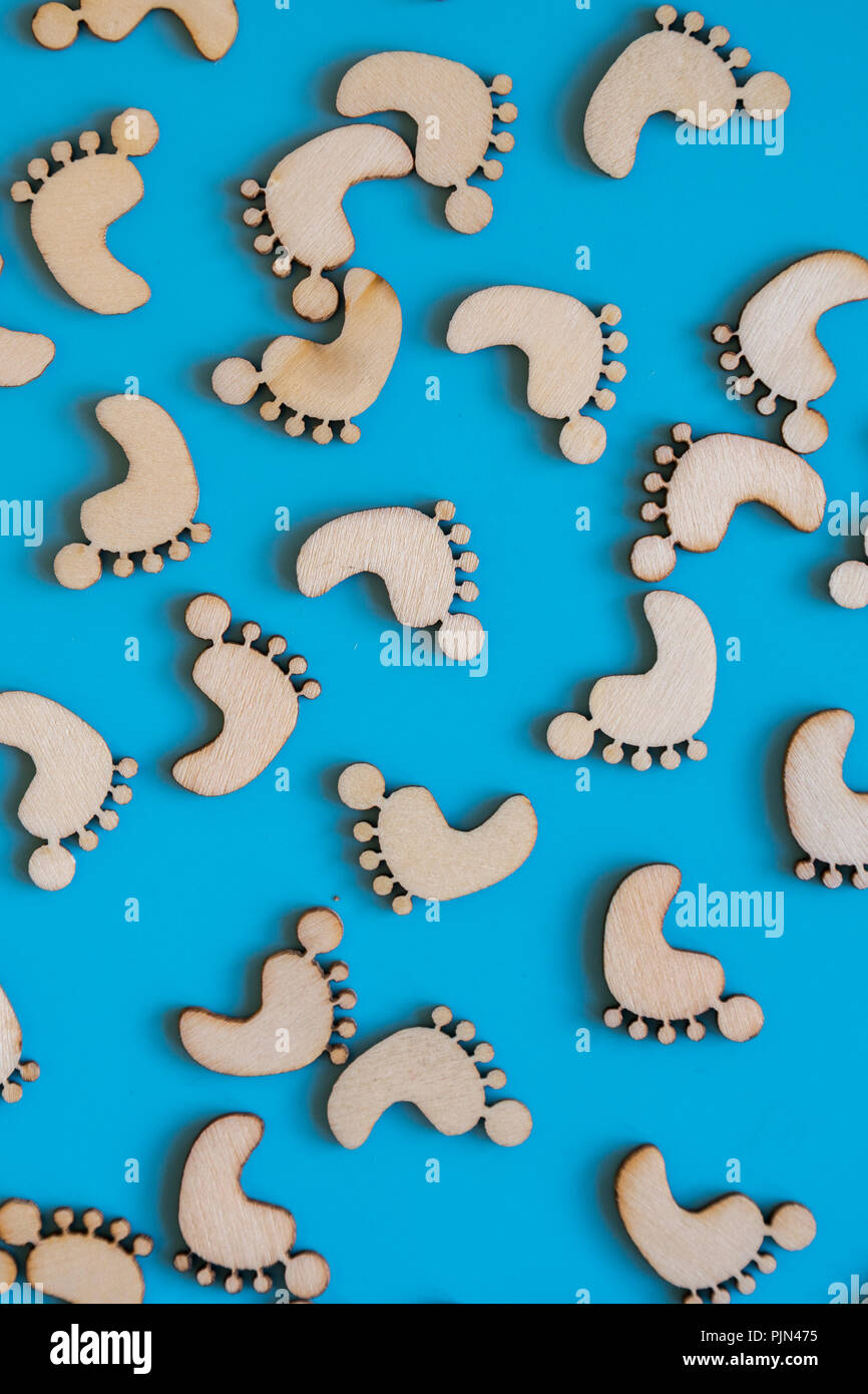 Footprints on a blue background. Wooden traces are scattered on a blue ...