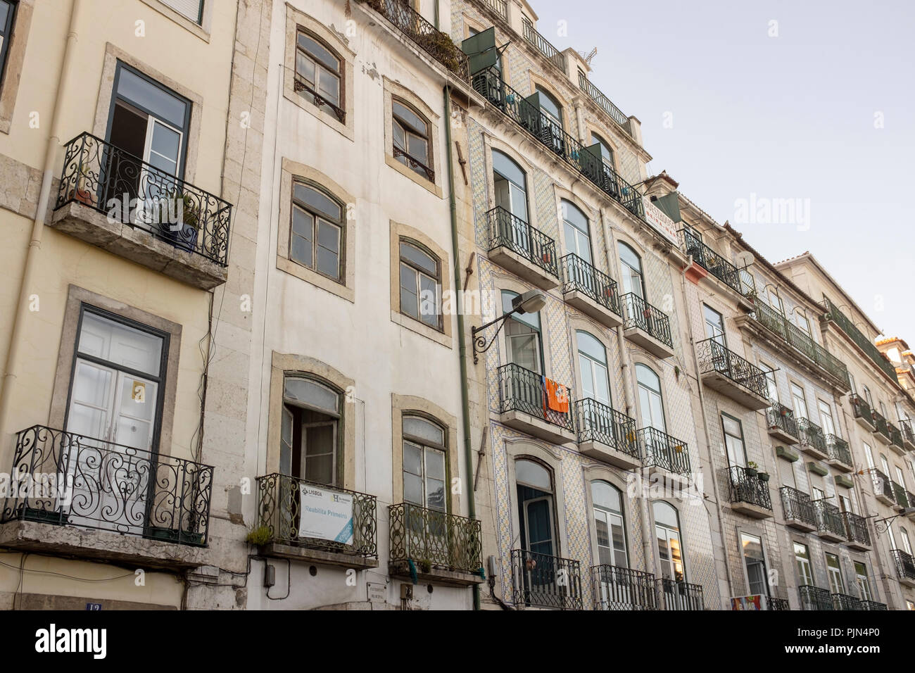 The facade of old apartment buildings in Lisbon, Portugal, with wrought ...