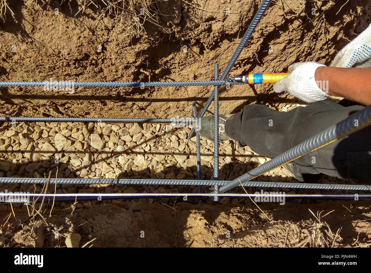 reinforcement of concrete with metal rods connected by wire and wooden ...