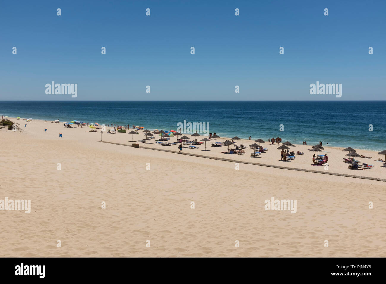Umbrellas and people at Praia do Pego, also known as Pego Beach ...