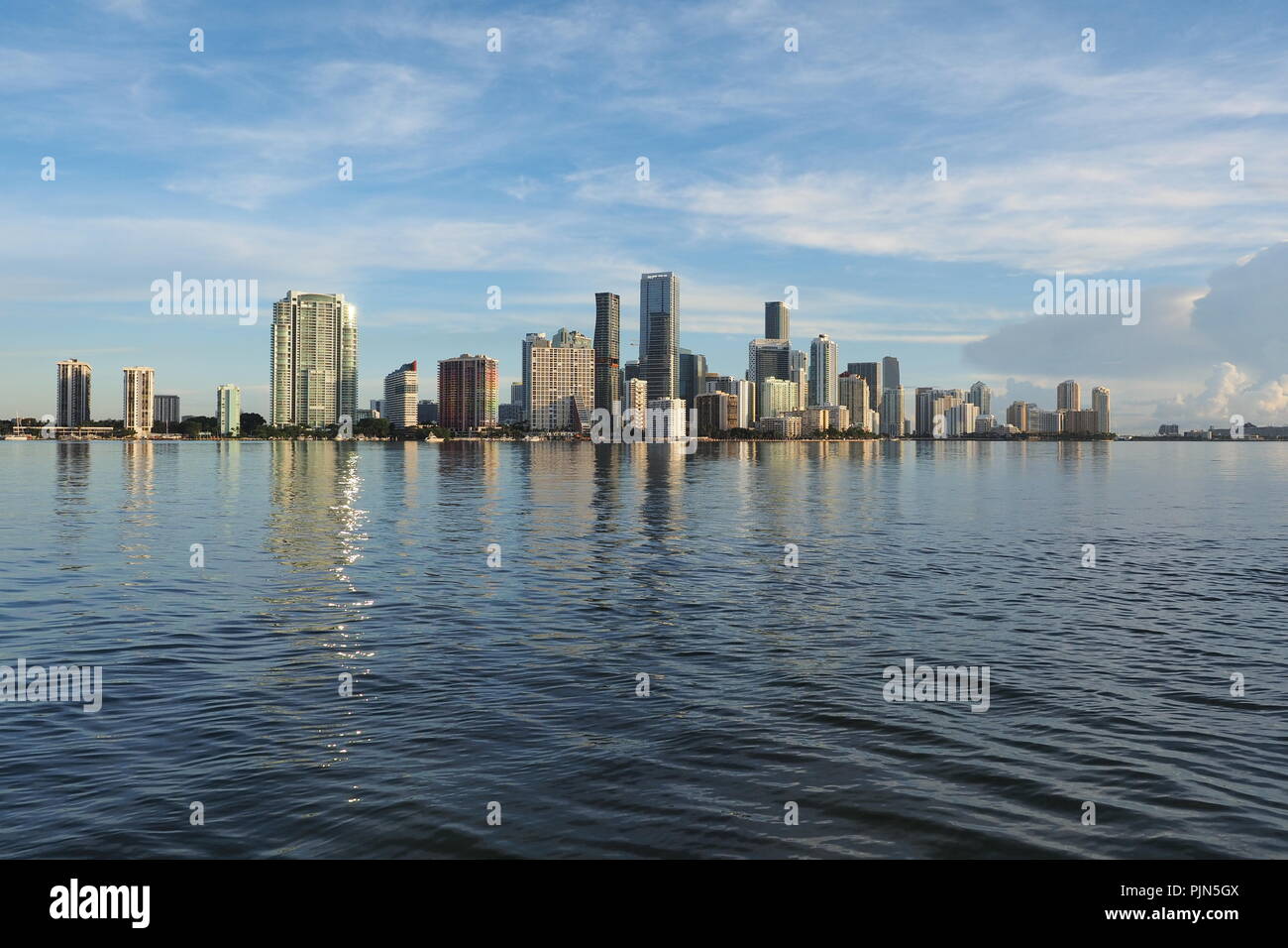 The City of Miami skyline and its reflection on the tranquil water of ...
