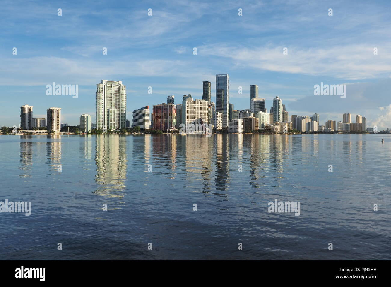 The City of Miami skyline and its reflection on the tranquil water of ...