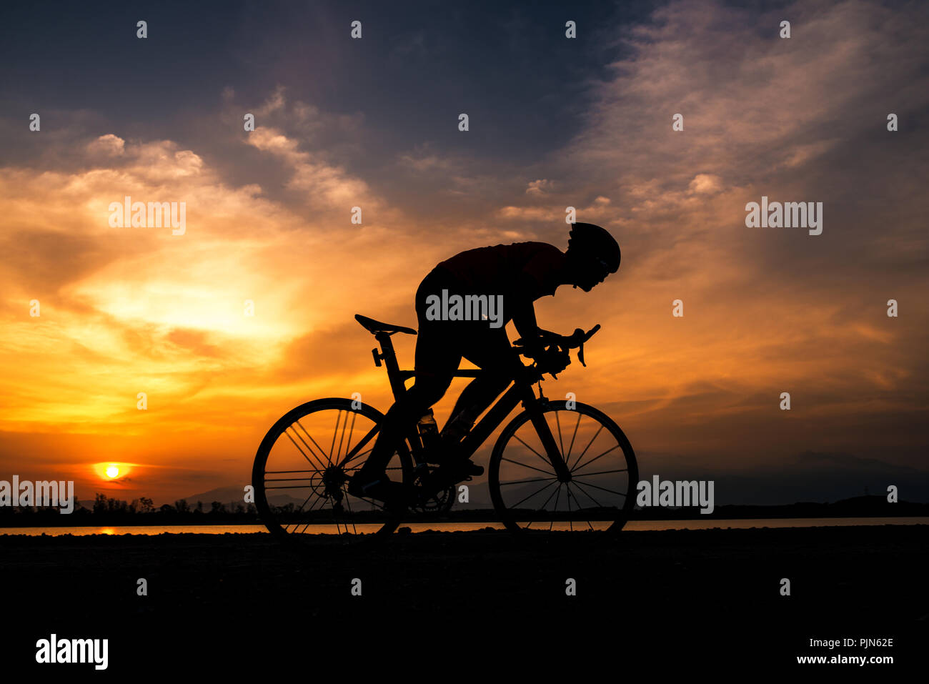 A cyclist riding a road bike on road in the moring Stock Photo - Alamy