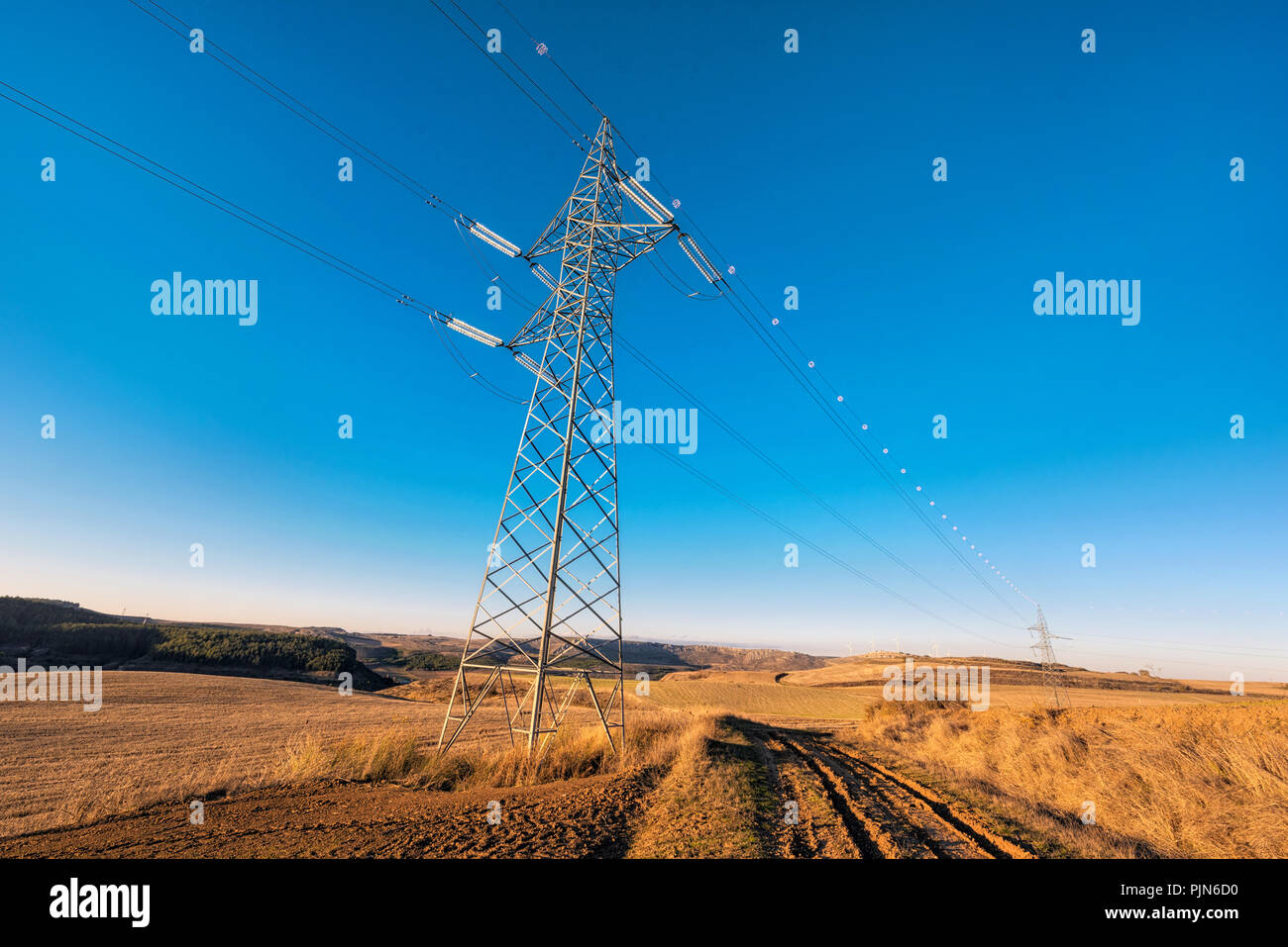 Electricity pylon on blue sunset sky Stock Photo - Alamy