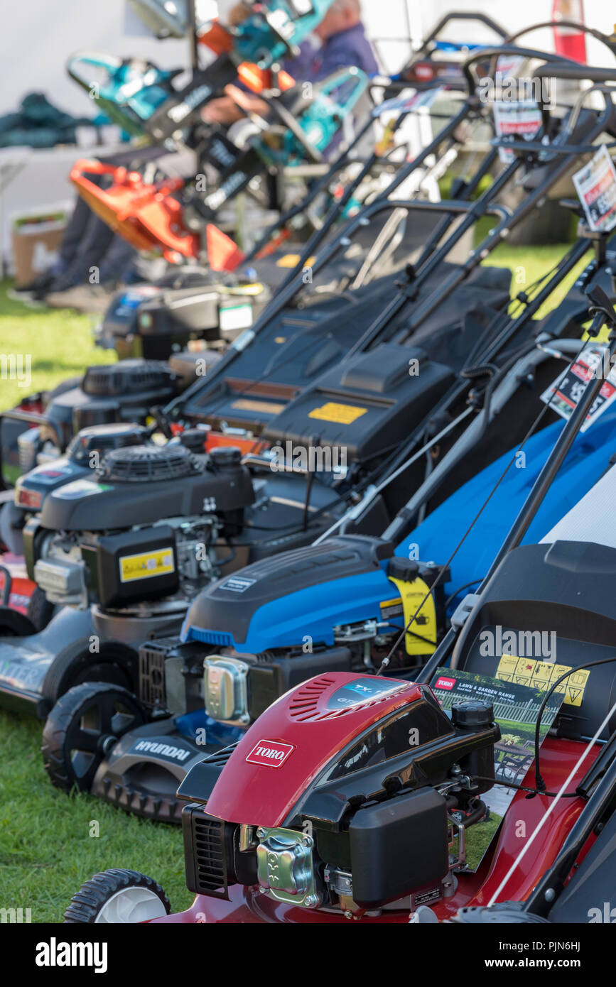 a display of new petrol powered lawn mowers o display at a garden show ...