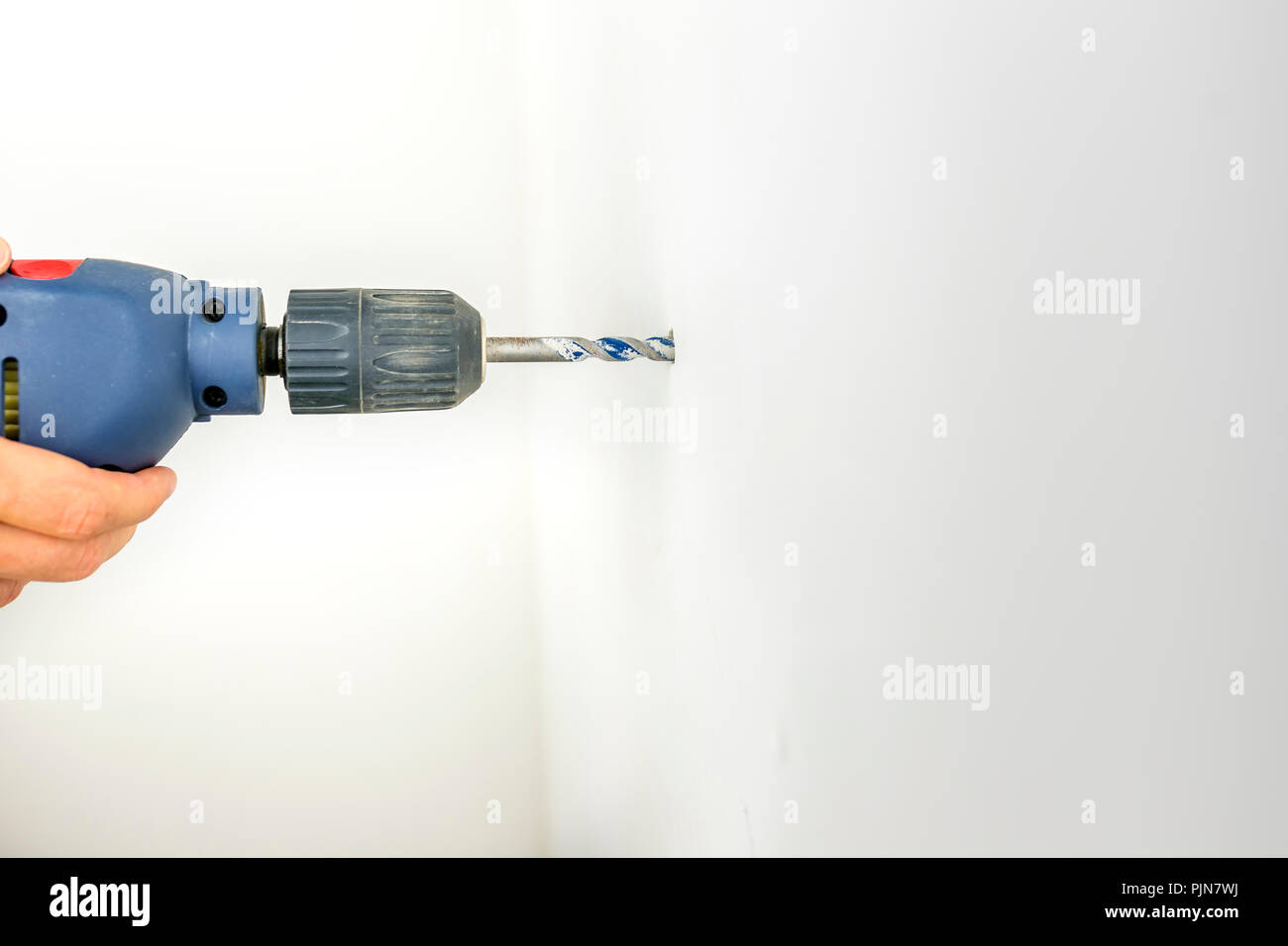 Closeup of drilling hole in the wall with drilling machine Stock Photo ...