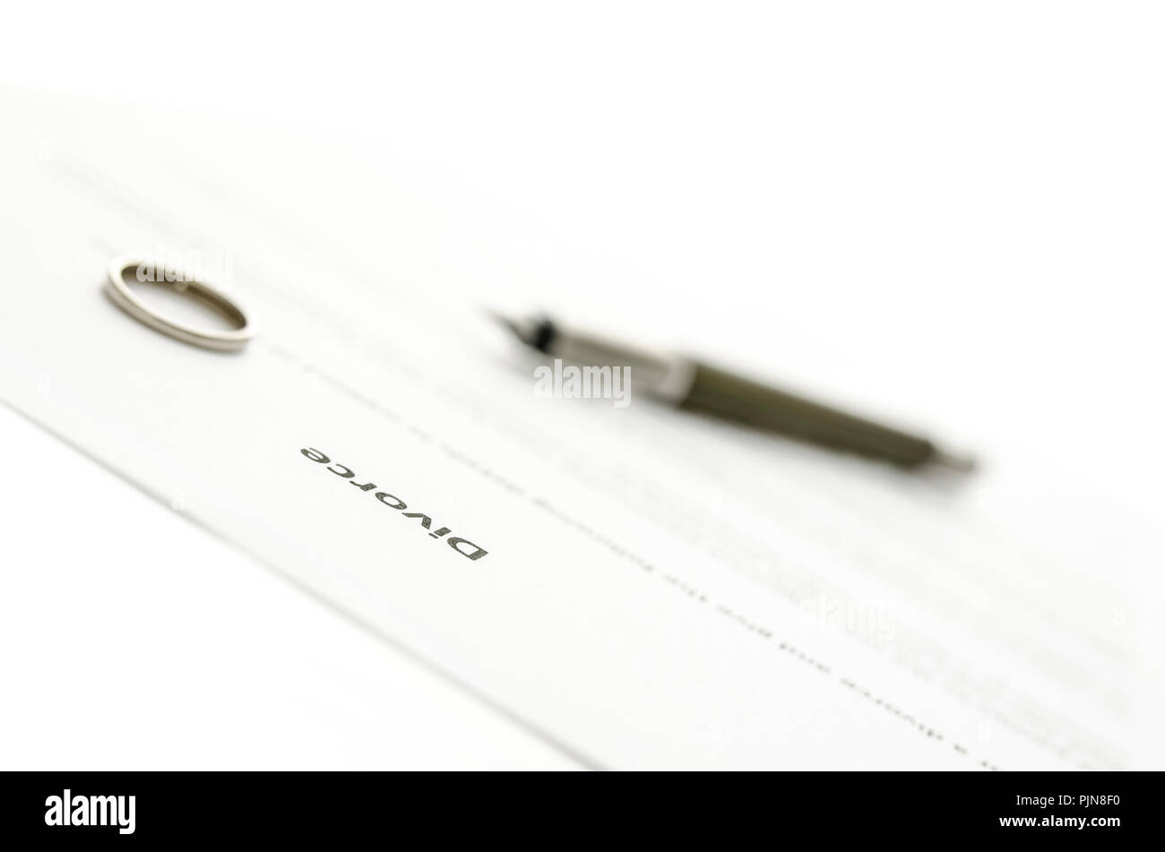 Wedding ring and ink pen on divorce papers. Concept of divorce. Shallow ...
