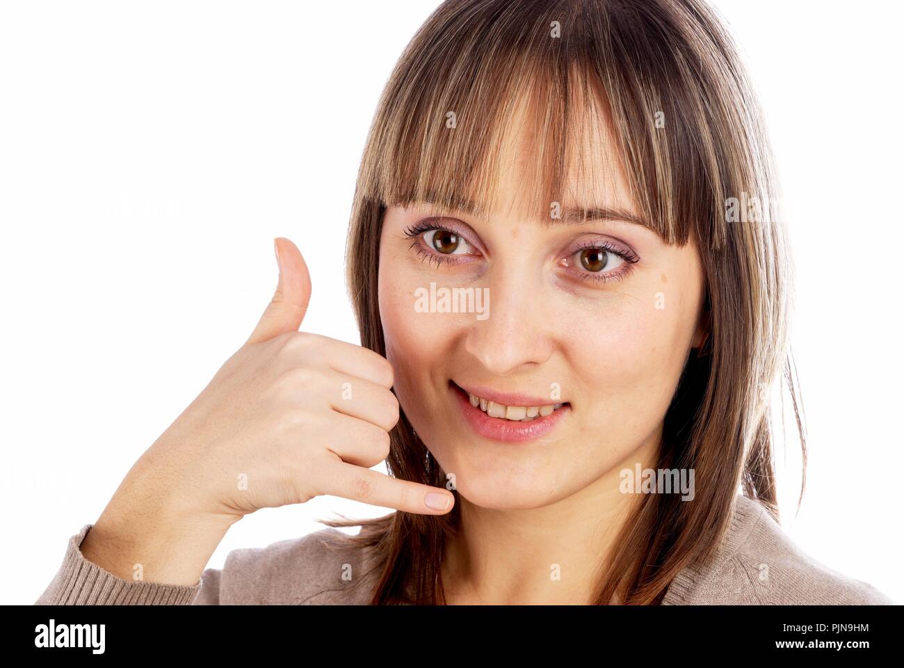 Beautiful woman making a call me sign and looking very happy Stock ...