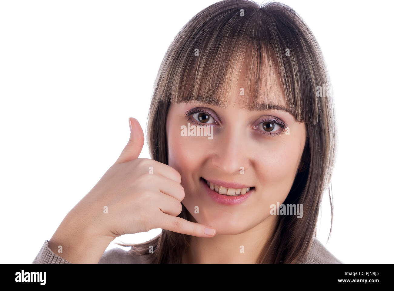 Beautiful woman making a call me sign and looking very happy Stock ...