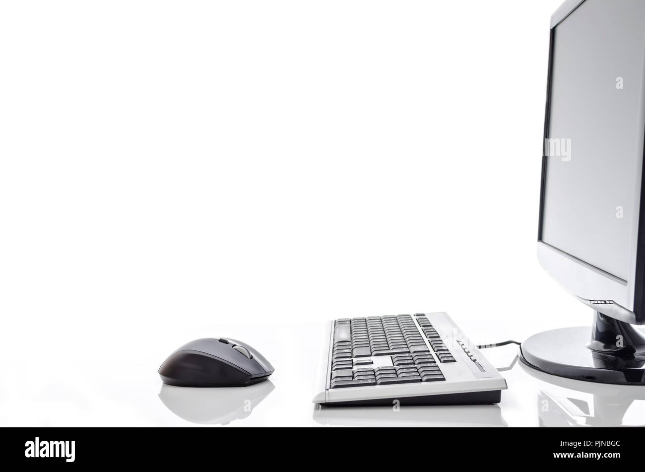 Computer on a white table with reflection Stock Photo - Alamy